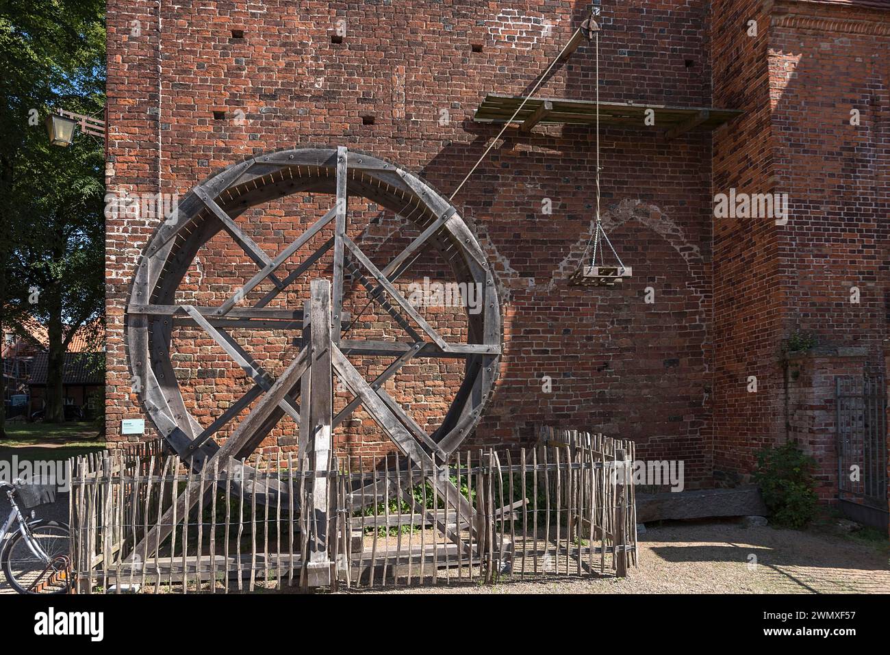 Medieval wooden wheel for lifting building materials, in front of the ...