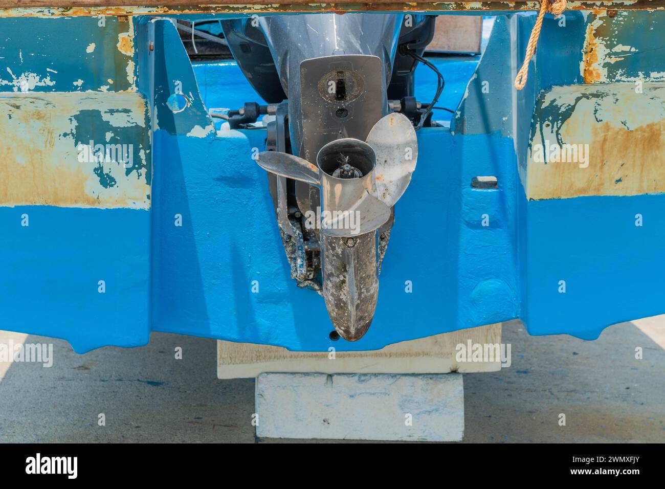 Closeup of propeller and rudder shaft of outboard engine on small boat ...