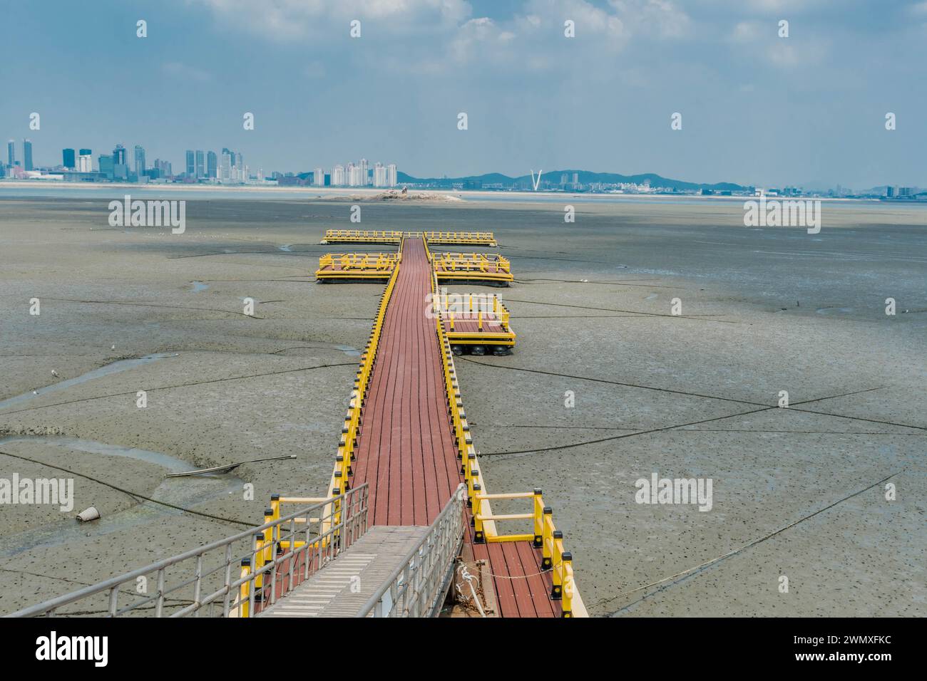 Long yellow floating pier at ocean port during low tide in South Korea ...