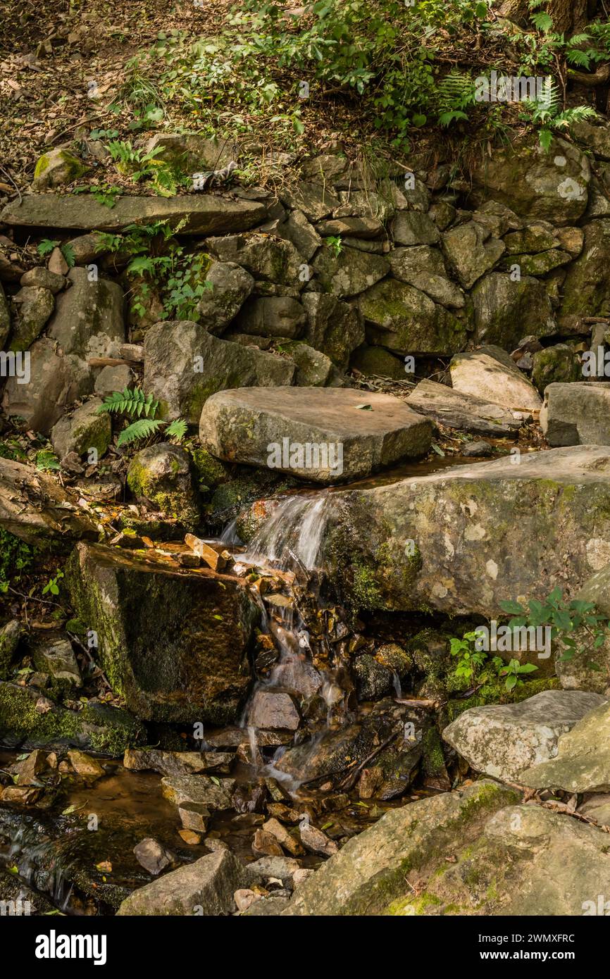Small stream flowing over rocks and boulders in mountain park, in South ...