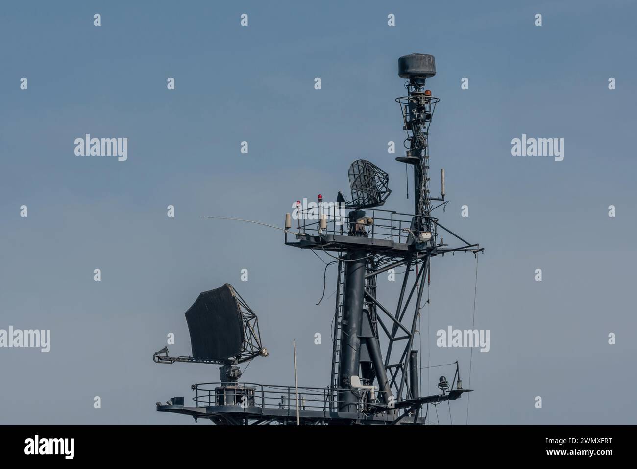 Communications tower on naval frigate (not shown) against clear blue ...