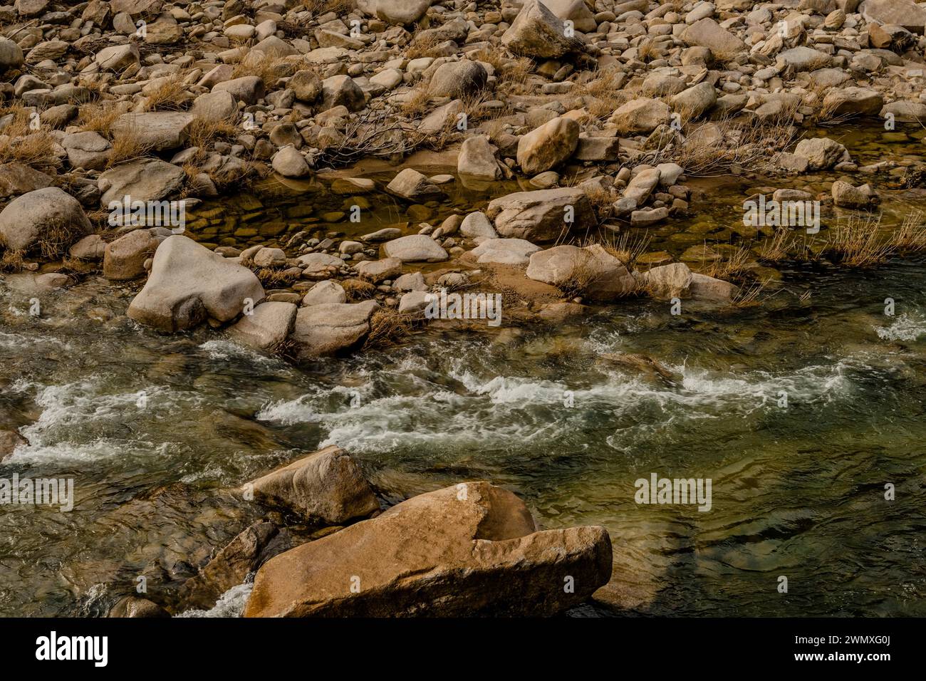 Water in river flowing over large rocks and boulders, in South Korea ...