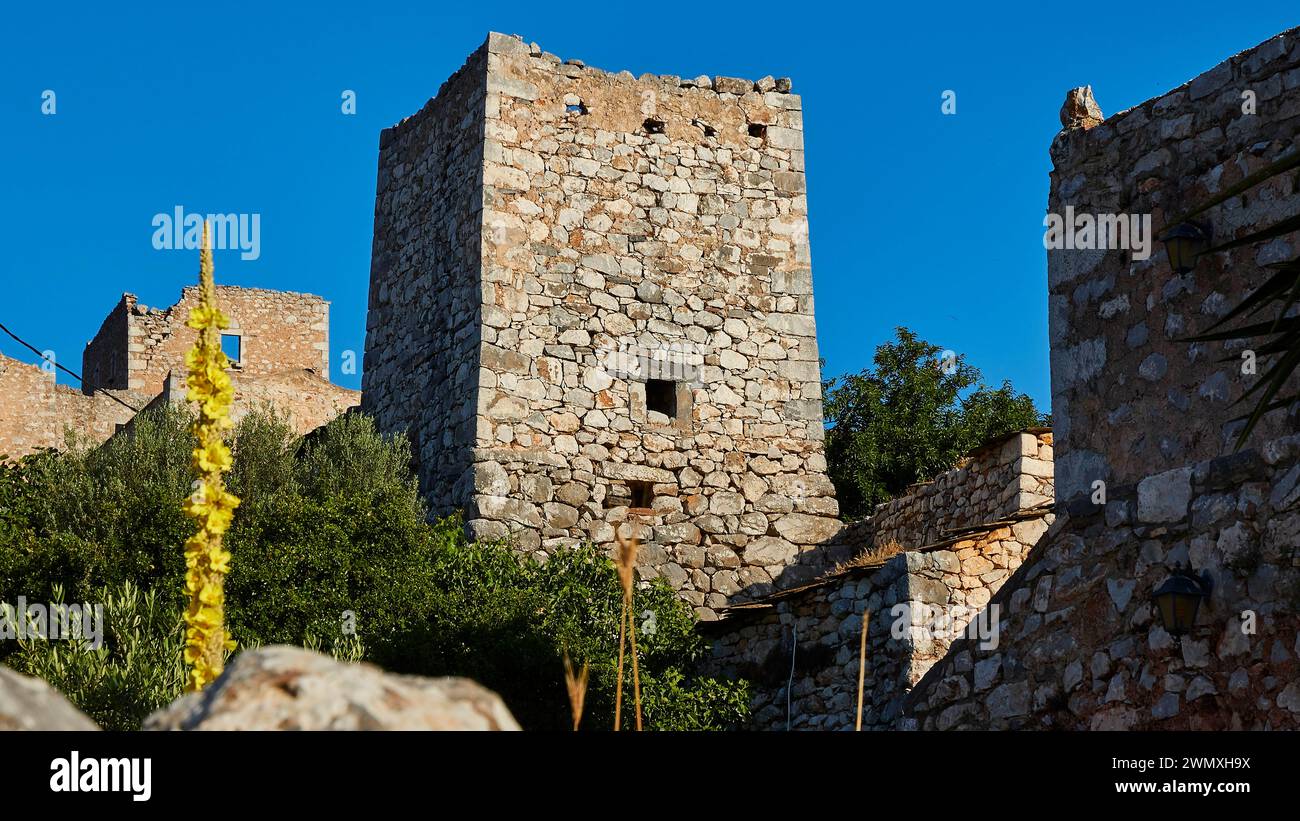 Medieval stone towers surrounded by Mediterranean vegetation under a ...