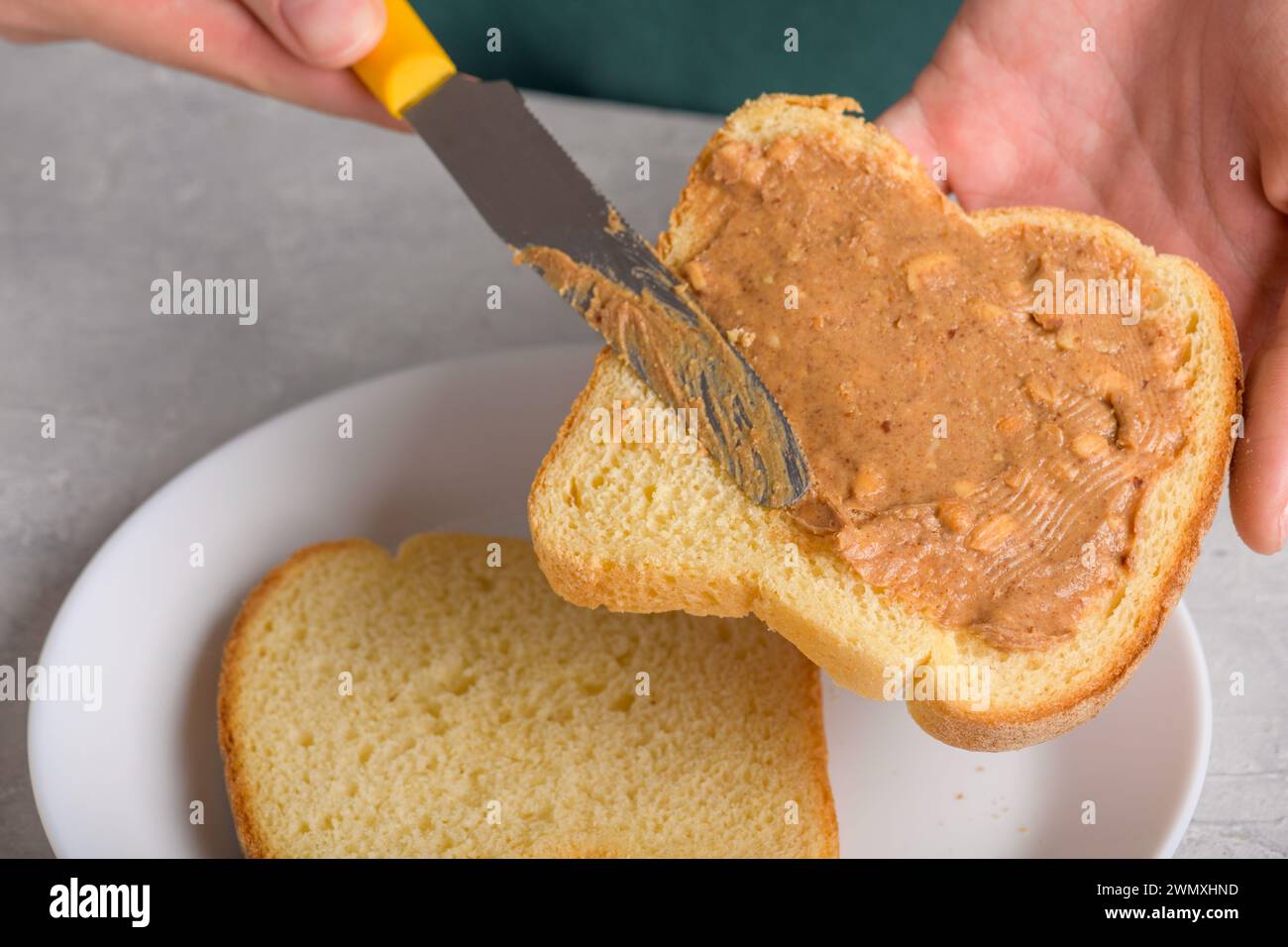 Hands spreading butter toast hi-res stock photography and images - Alamy