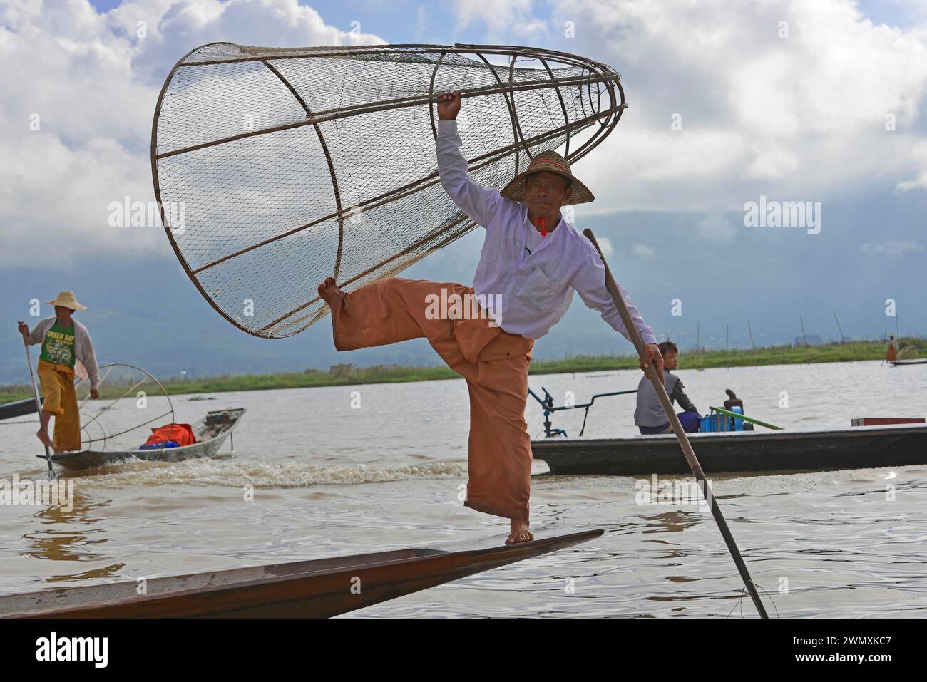 Intha fisherman, local man fishing with traditional conical fishing net ...
