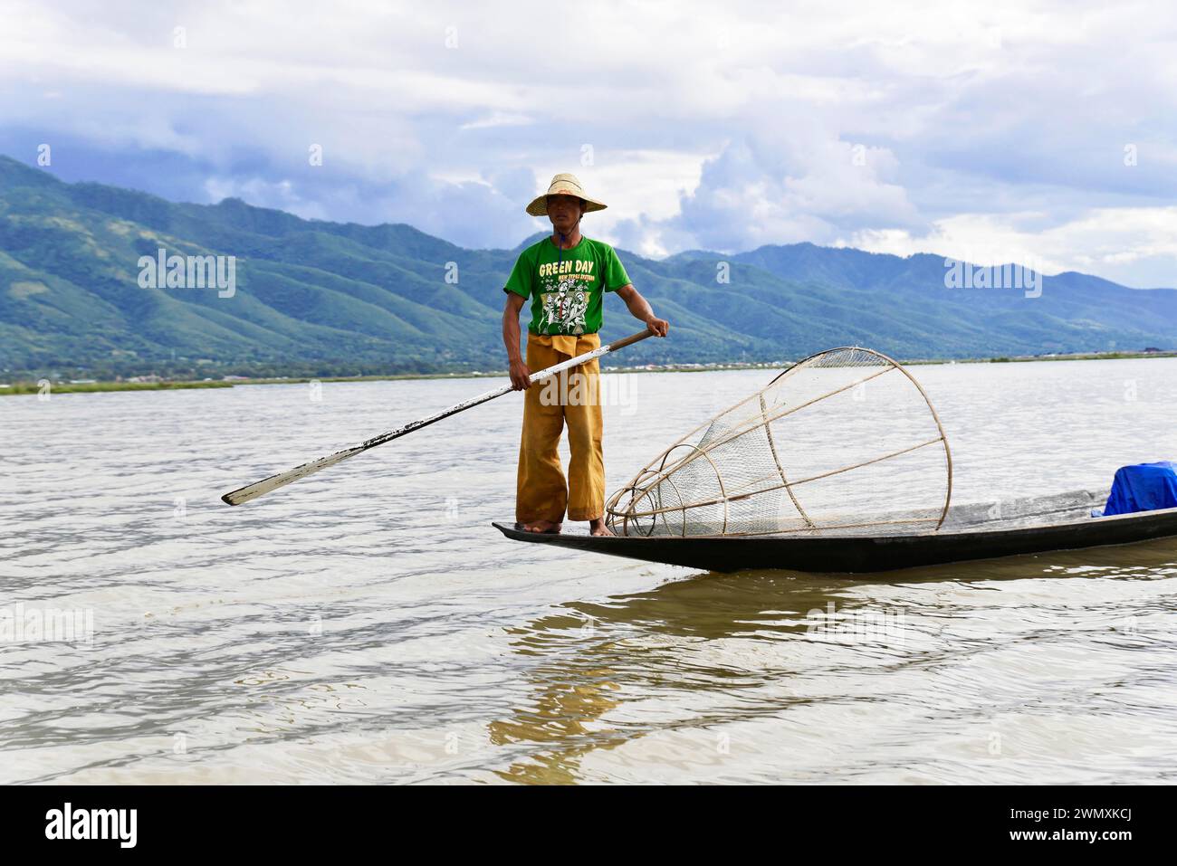 Intha fisherman, local man fishing with traditional conical fishing net ...