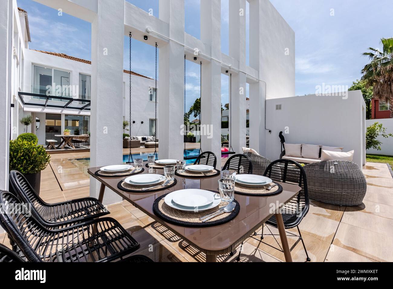 an image of outdoor dining table set up with plates and ready for a ...