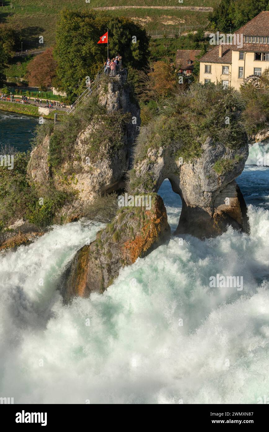 Rhine Falls seen from Laufen Castle, rocky island, Swiss flag, spray ...