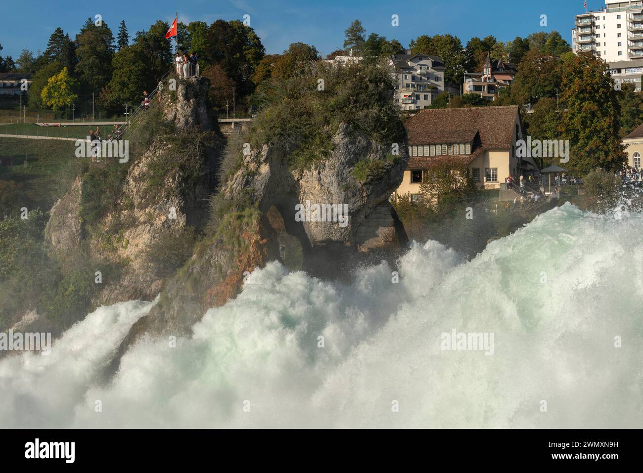 Rhine Falls seen from Laufen Castle, rocky island, Swiss flag, spray ...