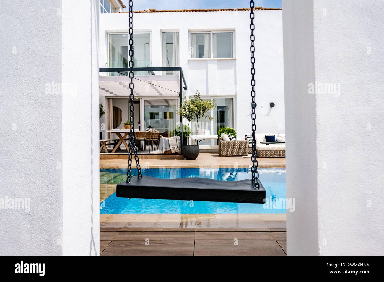 a single swing next to an infinity swimming pool in a luxury ...