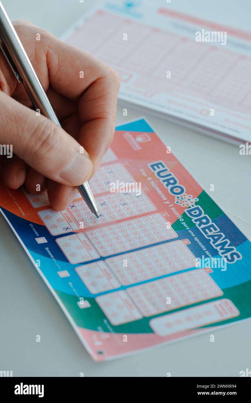 Barcelona, Spain - February 13, 2024: A man picks numbers from a Euro ...