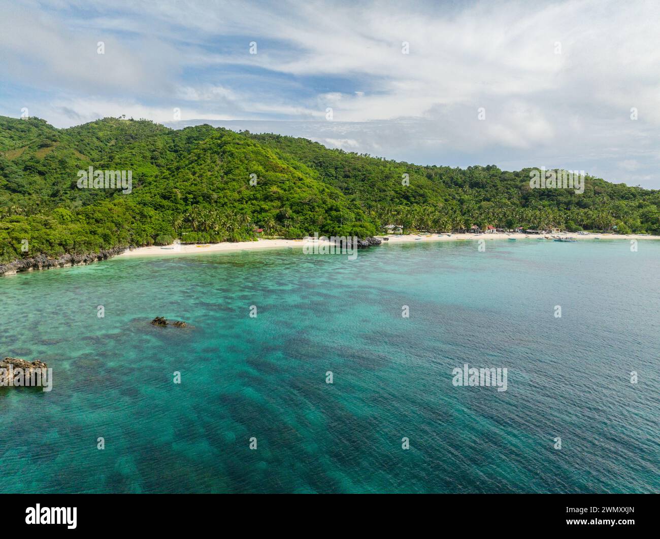 Greenish water with coral reefs and white sand beach. Cobrador Island ...