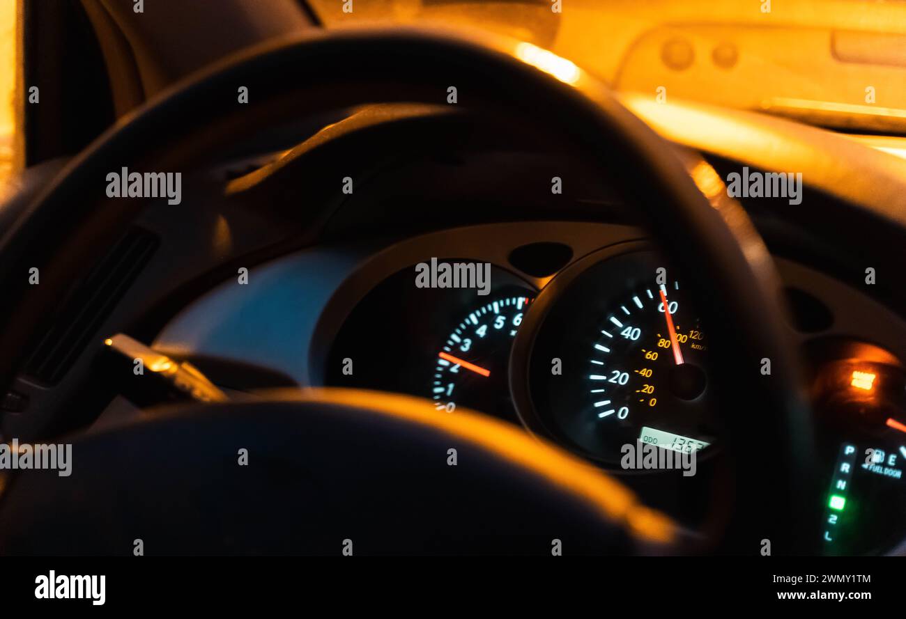 A mesmerizing view of blurred lights and dashboard inside a moving car ...