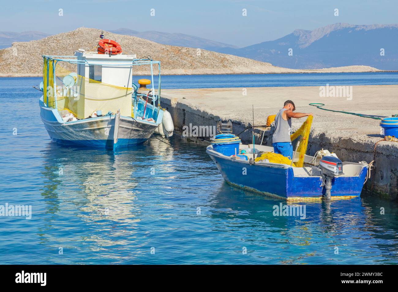 Greece, Dodecanese islands, Halki island, Fisherman working Stock Photo ...