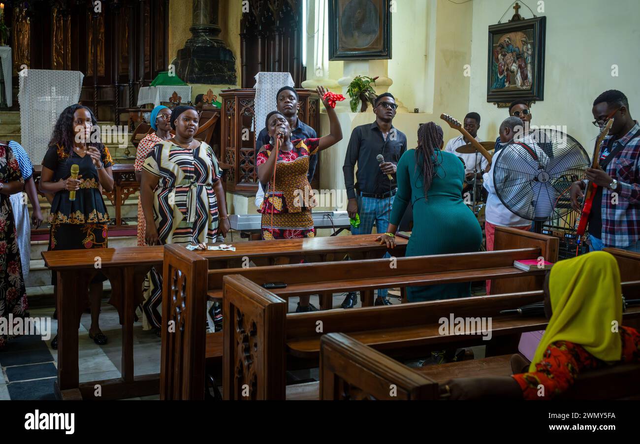 A band plays as a woman and other worshippers sing on Sunday in the ...