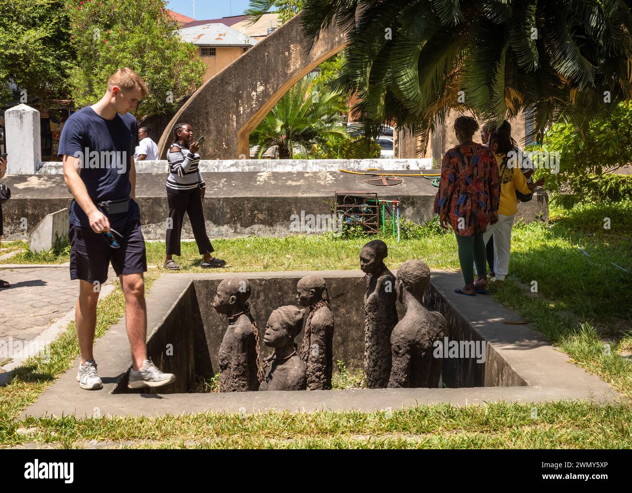 A western tourist visits the memorial sculpture to slaves at the old ...