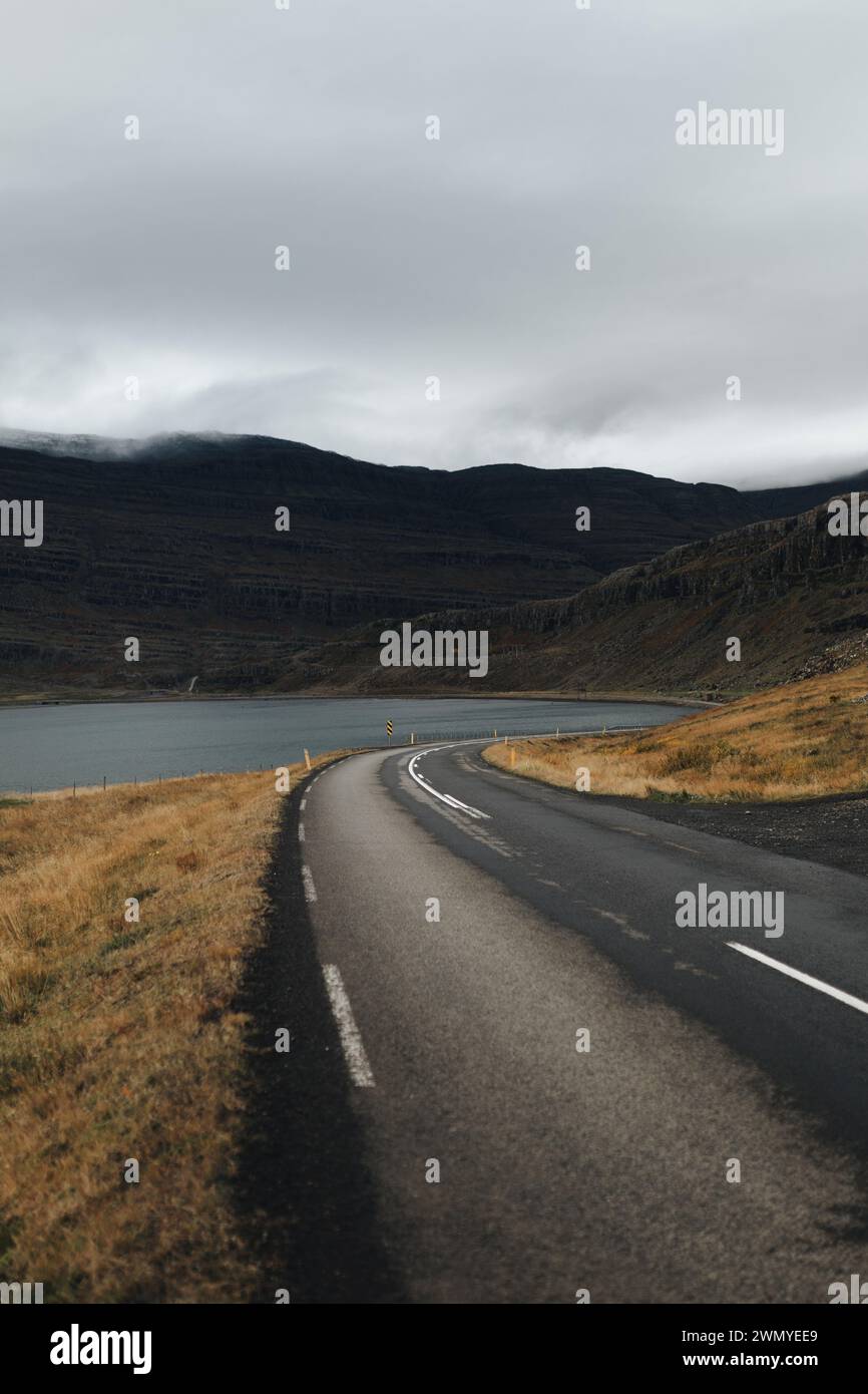 An empty winding road meanders through the dramatic Icelandic landscape ...