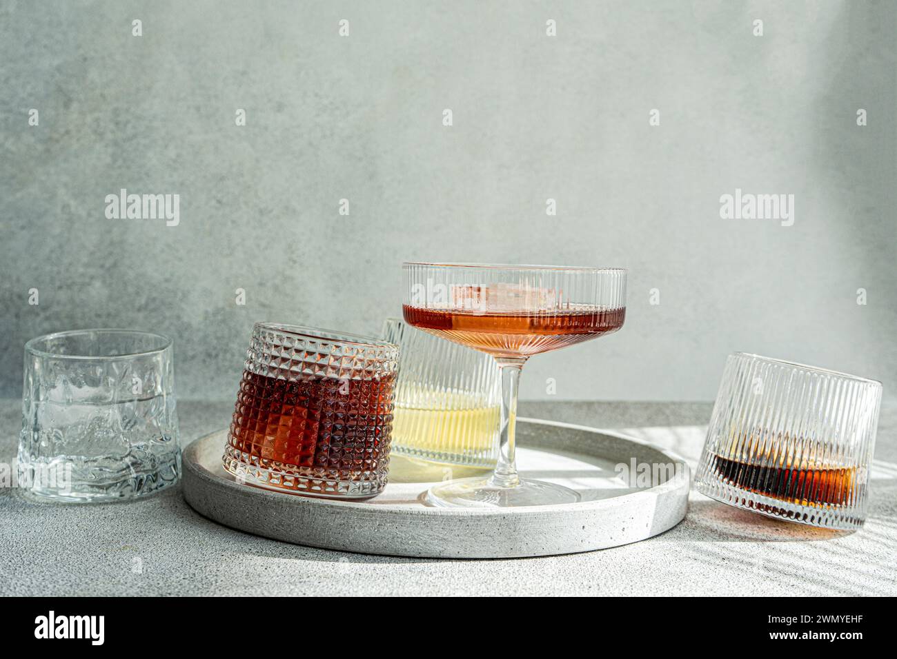 A selection of alcoholic drinks in textured glasses, elegantly ...