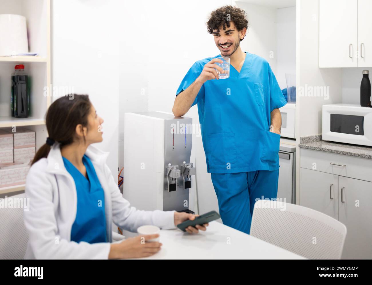 Doctor drinking water in clinic hi-res stock photography and images - Alamy