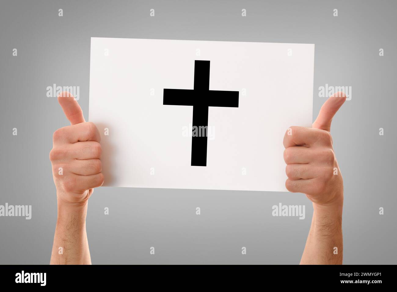 Hands of a religious man with okay sign holding a white sign with drawn ...
