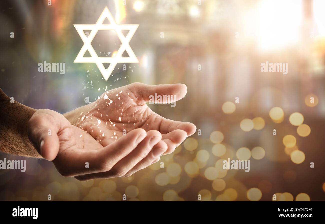 Hands together of religious person with star floating with glitters and ...