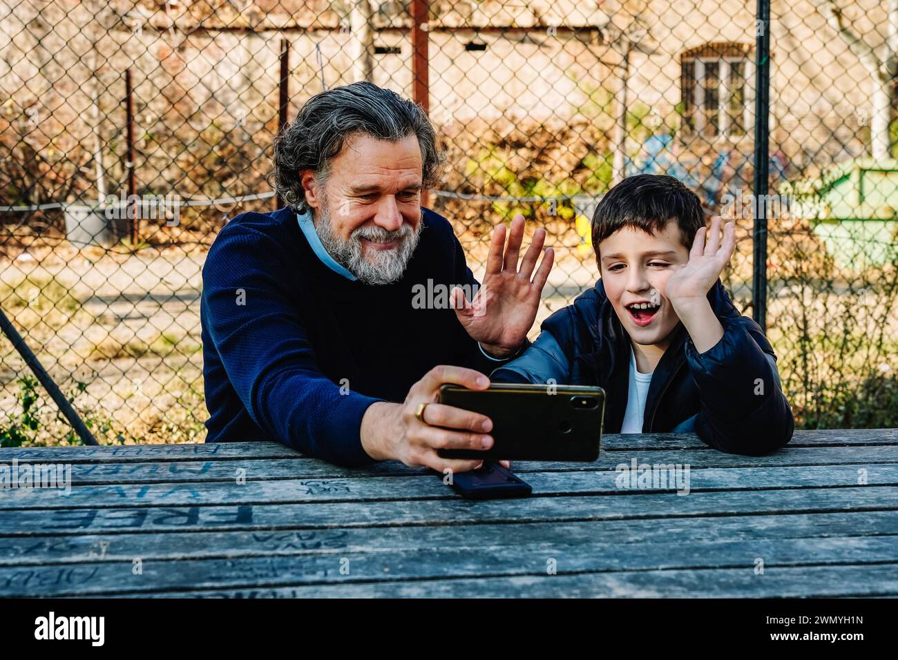 Family members sitting by table hi-res stock photography and images - Alamy