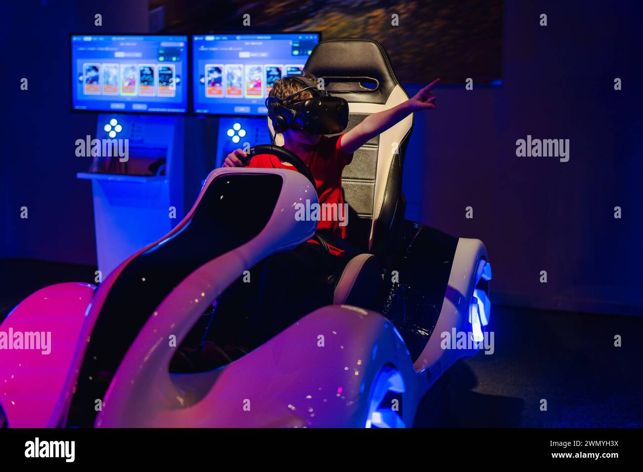 Excited child with a VR headset on gesturing while sitting in a sleek ...
