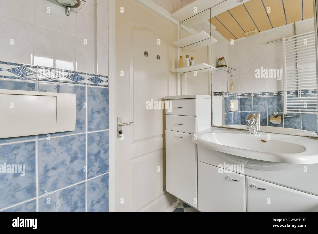 This stock photo showcases a well-lit bathroom with a distinctive blue ...