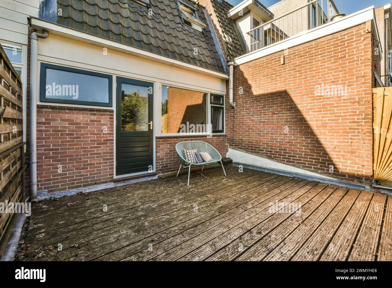 A tranquil suburban patio featuring a single modern chair, wooden ...