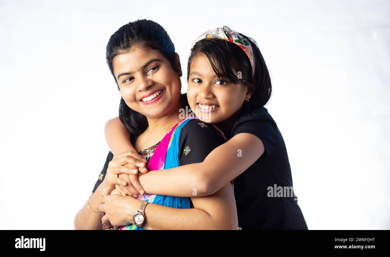 Indian mother and child daughter embracing hugging each other with ...