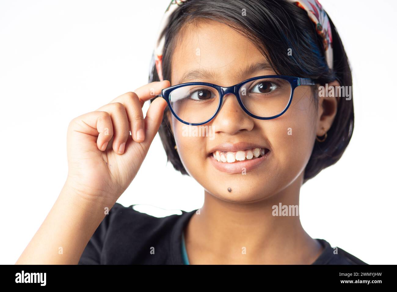 Head shot portrait of a young beautiful Indian girl child wearing dark ...
