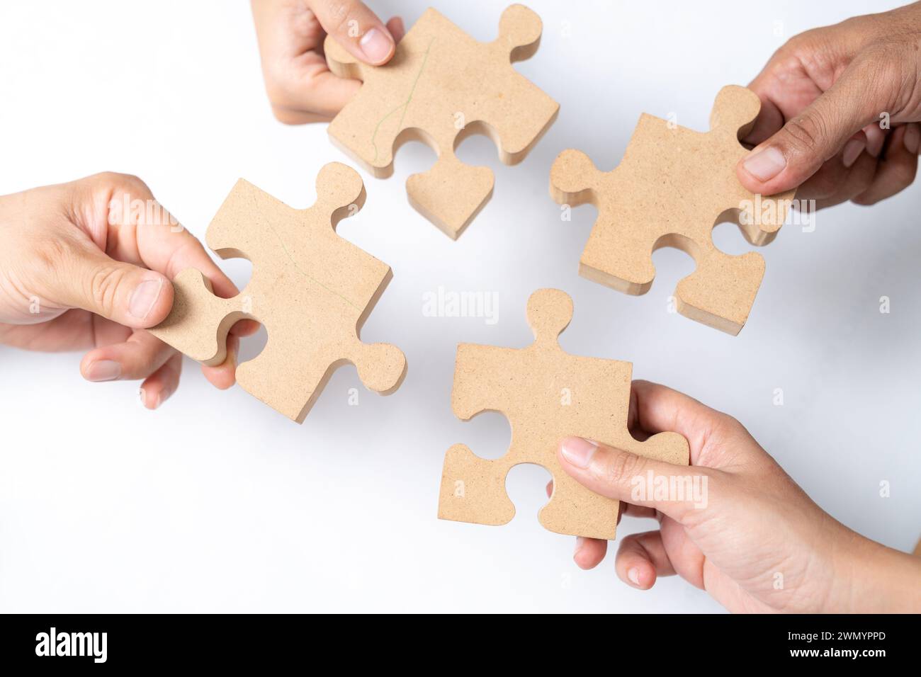 The hands that are helping each other assemble the jigsaw puzzle ...