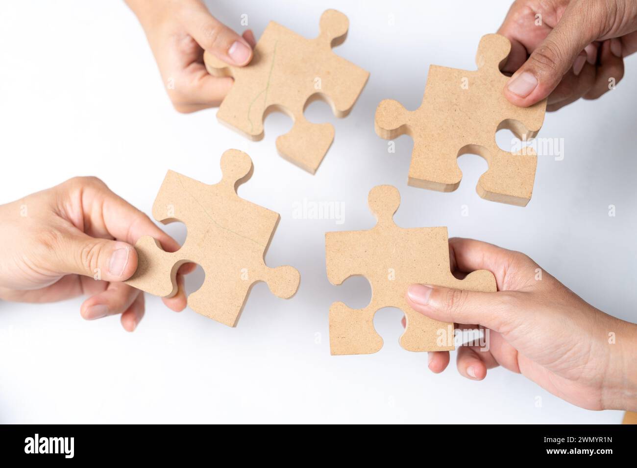The hands that are helping each other assemble the jigsaw puzzle ...