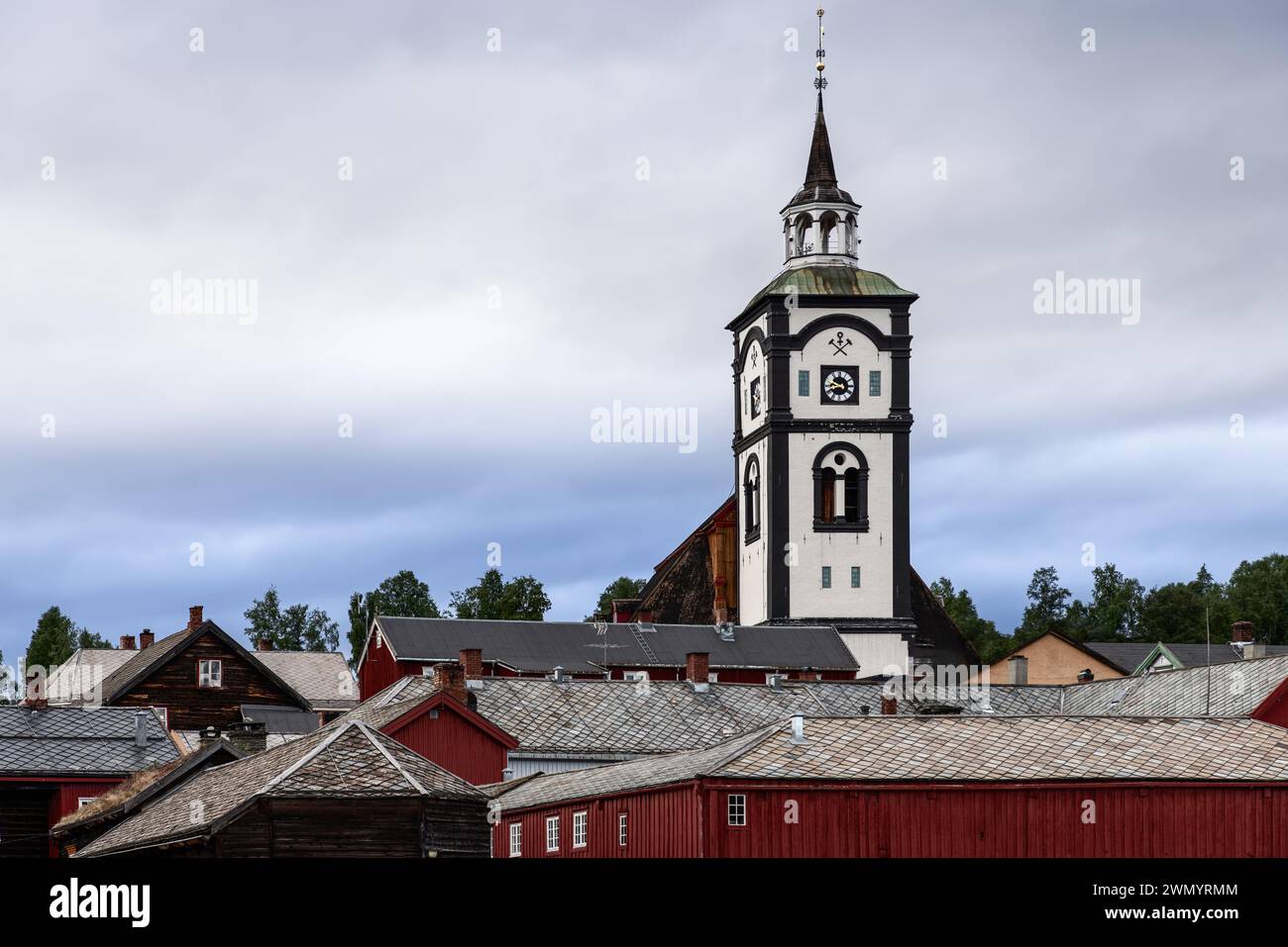 The Roros Church stands amidst of traditional Scandinavian wooden homes ...