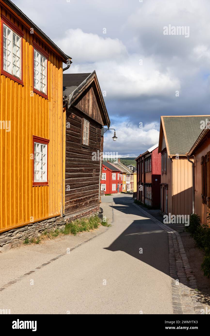 Sunlit street in Roros, Norway, showcasing the historic wooden ...