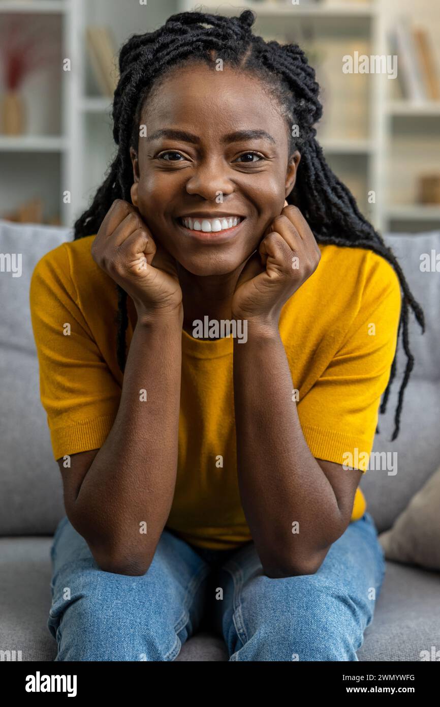 Cute smiling african american woman looking contented Stock Photo - Alamy