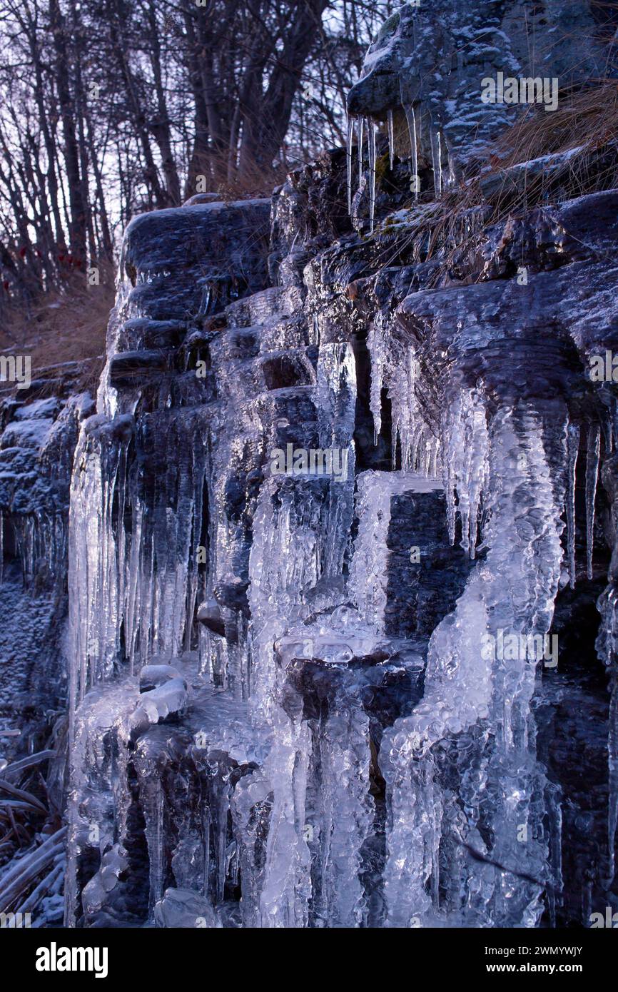 Frozen ice cycles hanging from rocks Stock Photo - Alamy