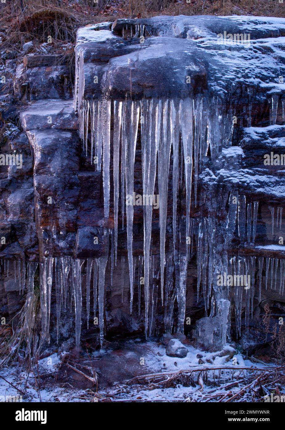 Frozen ice cycles hanging from rocks Stock Photo - Alamy