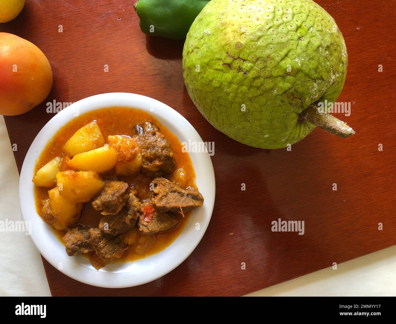 Breadfruit stew with sun-dried meat on a porcelain plate, a typical ...
