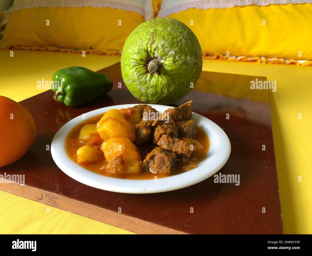 Breadfruit stew with sun-dried meat on a porcelain plate, a typical ...