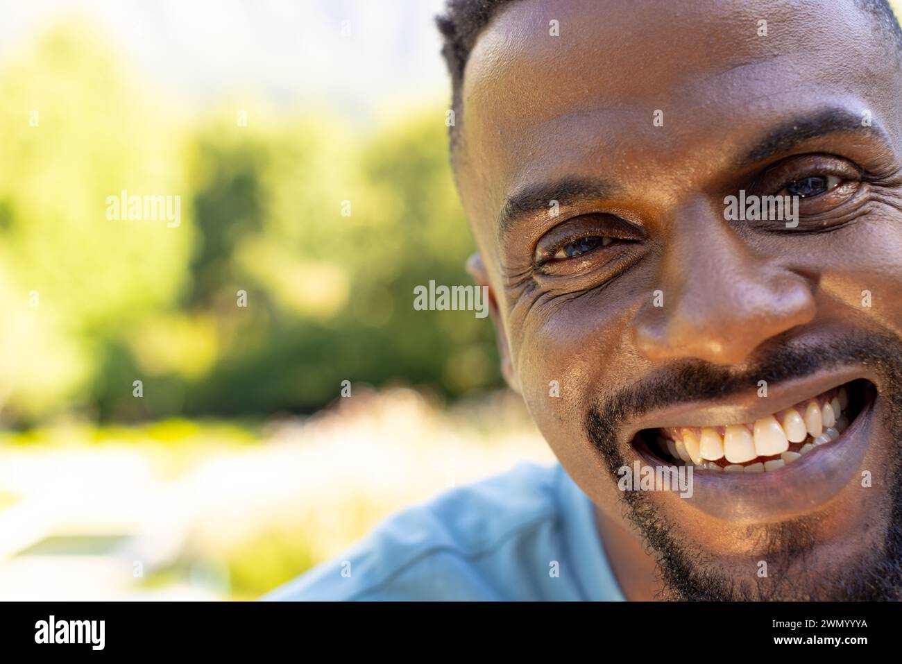 African American man smiles broadly, showcasing a warm expression at ...