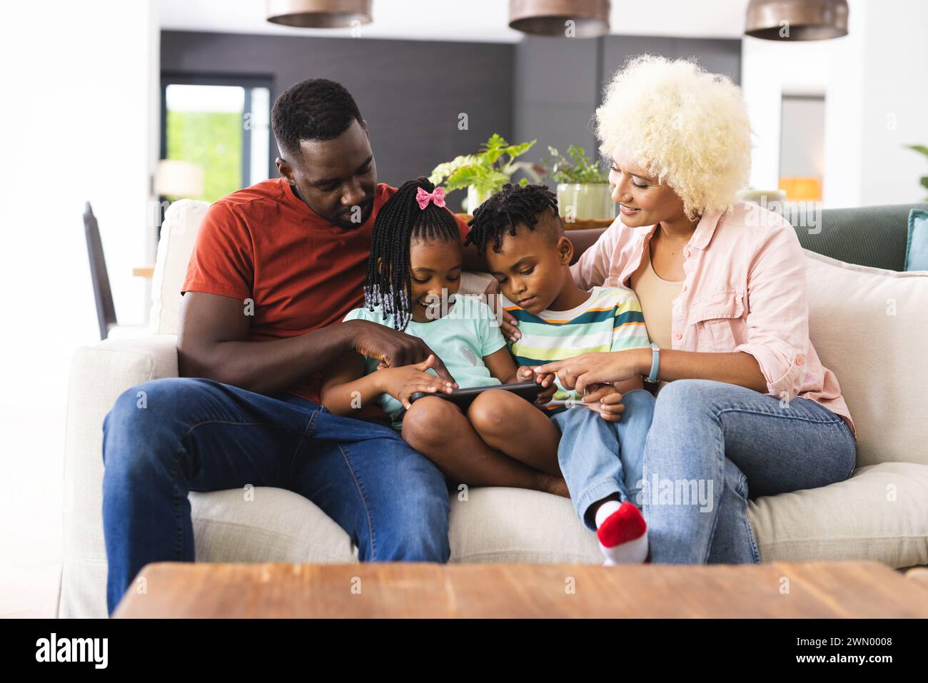 African American parents enjoy time with their daughter and son, all ...