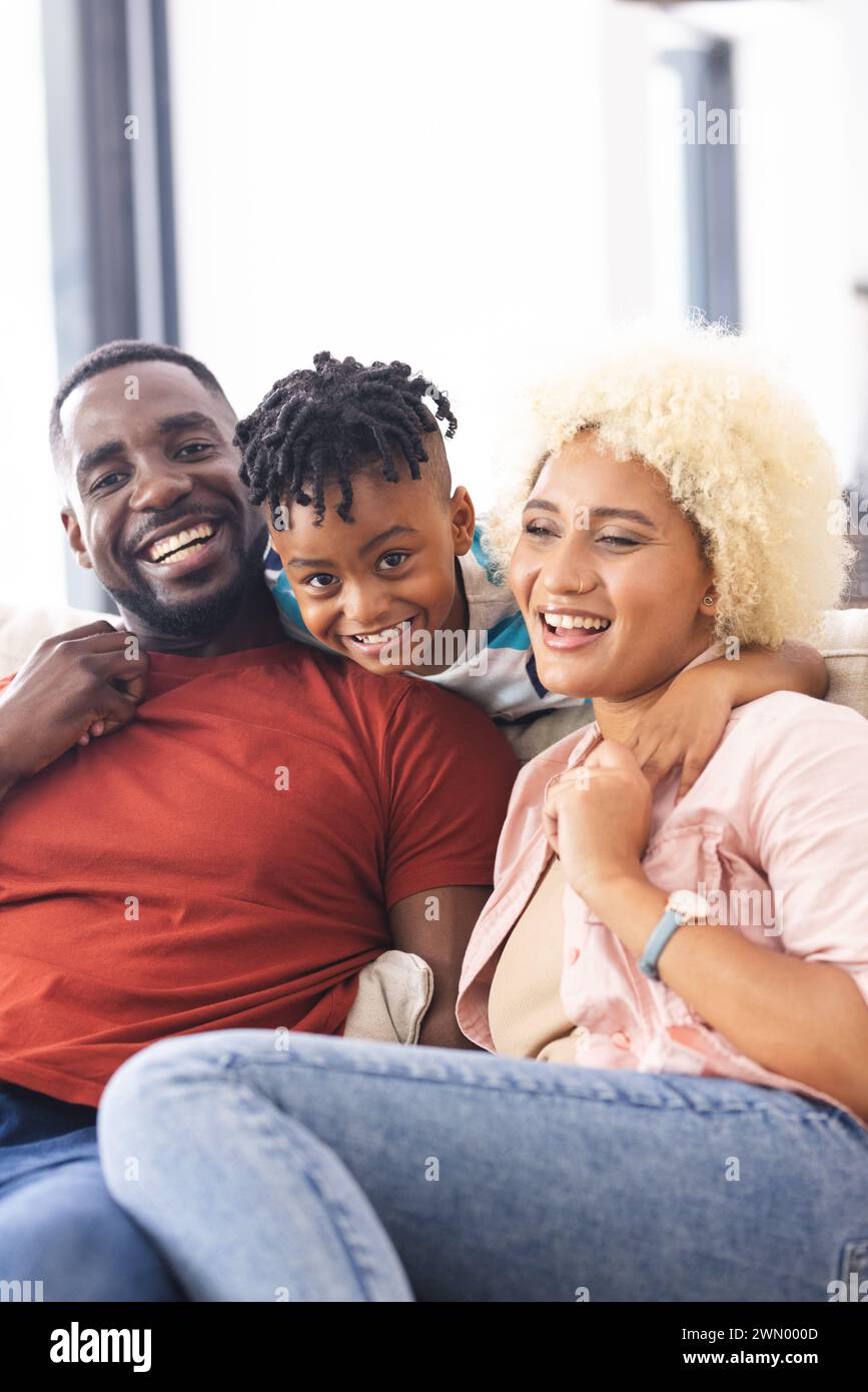 Happy biracial family smiling on the couch at home Stock Photo - Alamy