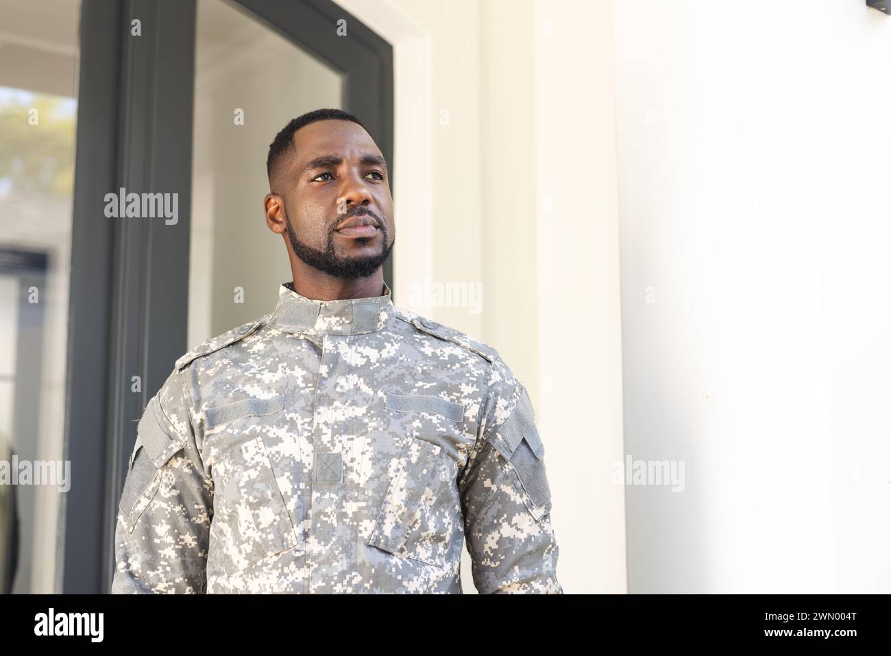 African American soldier in military uniform stands confidently with ...