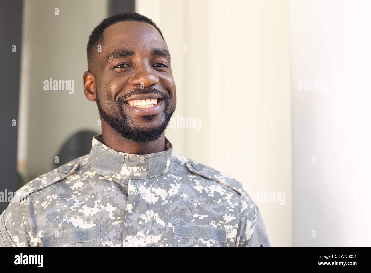 African American soldier in military uniform smiles warmly with copy ...