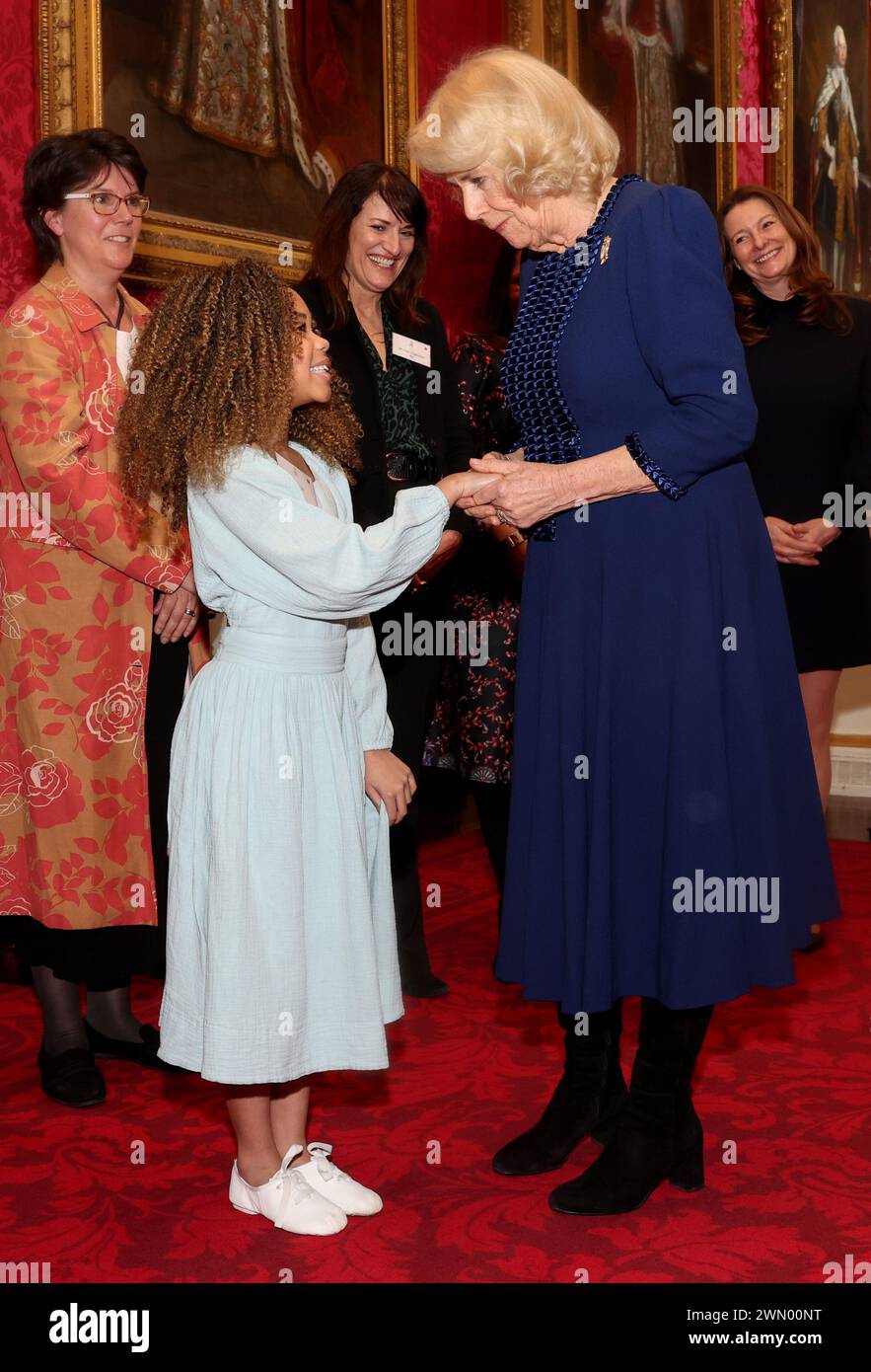 Queen Camilla shakes hands with nine year old Skylar Copeland during a ...