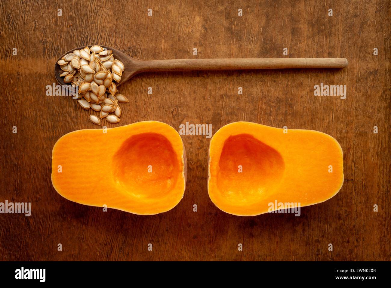 Two halves of sliced ripe butternut squash with seeds and vintage ...