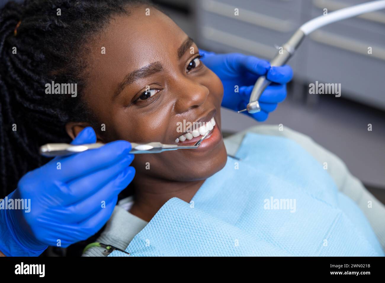 Multicultural lady in dental clinic doing teeth checkup Stock Photo - Alamy