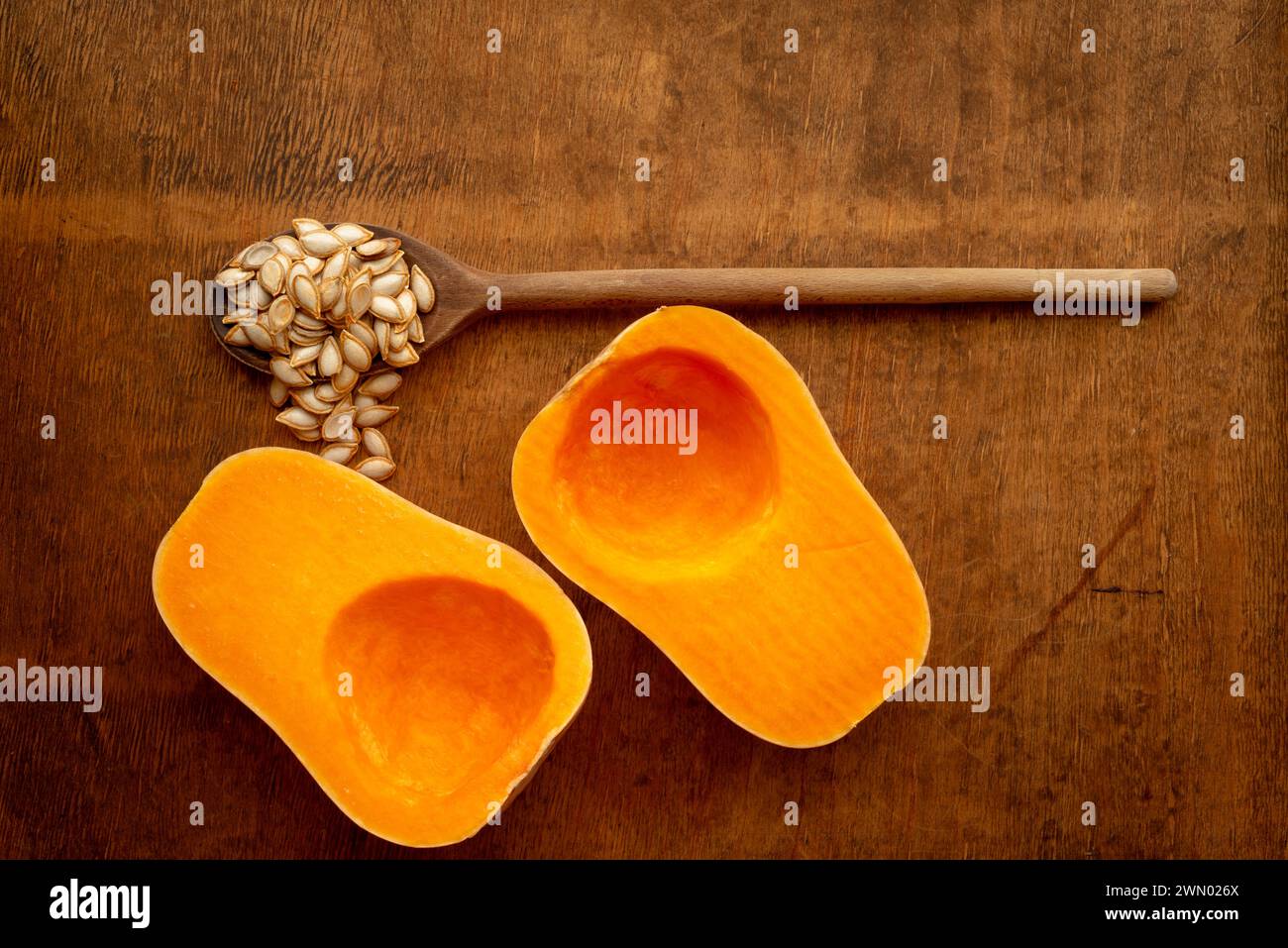 Two halves of sliced ripe butternut squash with seeds and vintage ...