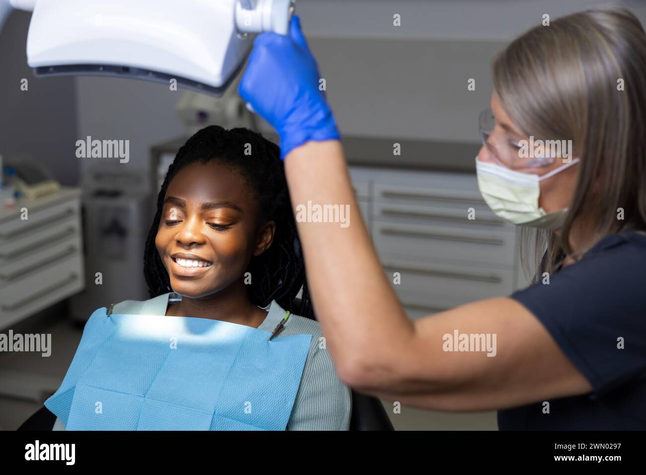 Multicultural lady in dental clinic doing teeth checkup Stock Photo - Alamy